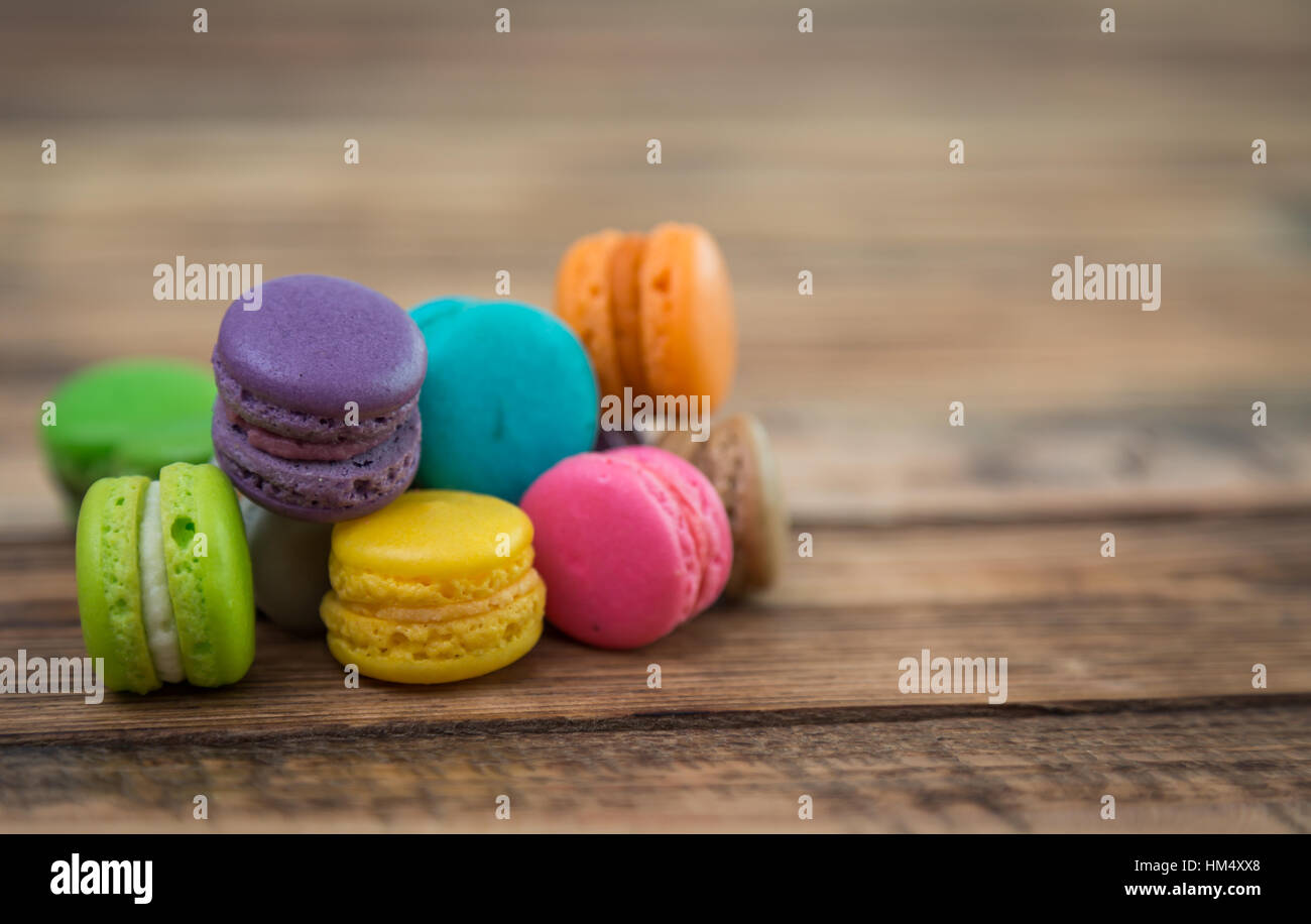 French colorful macarons on wood table Stock Photo - Alamy