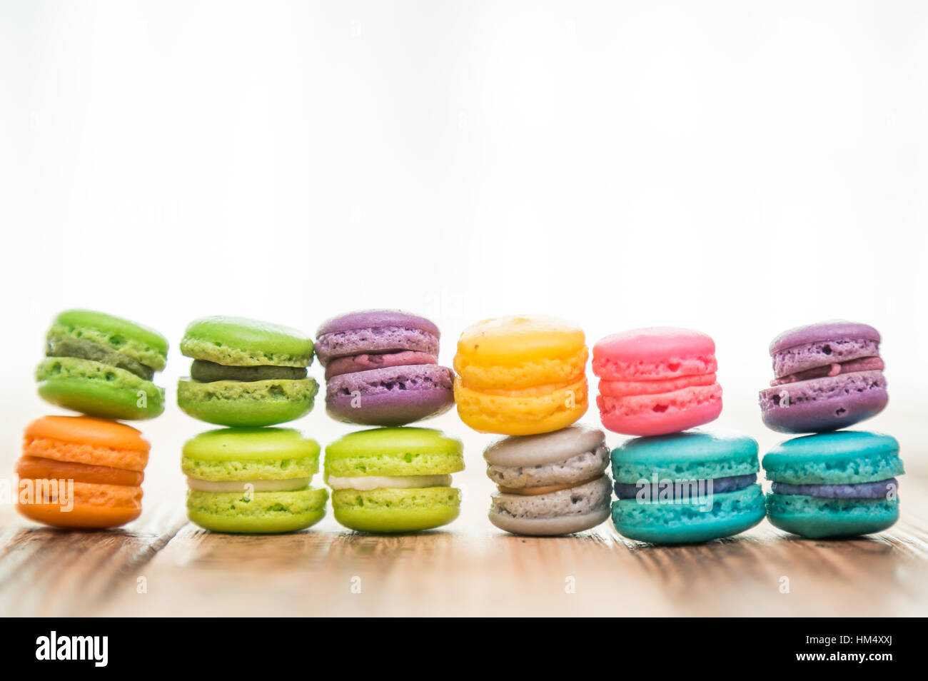 French colorful macarons on wood table Stock Photo - Alamy