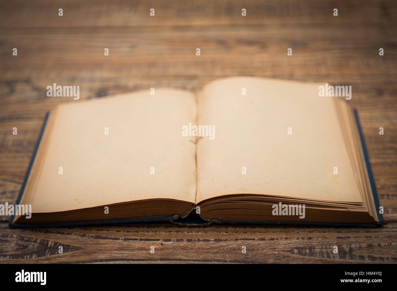 Open blank pages of old book on wood background Stock Photo - Alamy