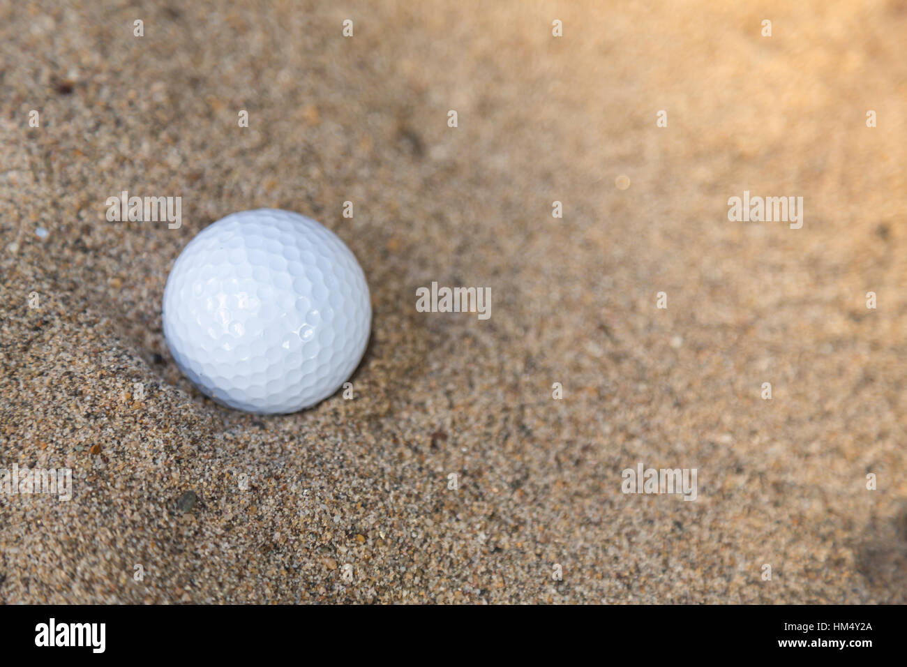 Golf ball in sand bunker Stock Photo - Alamy