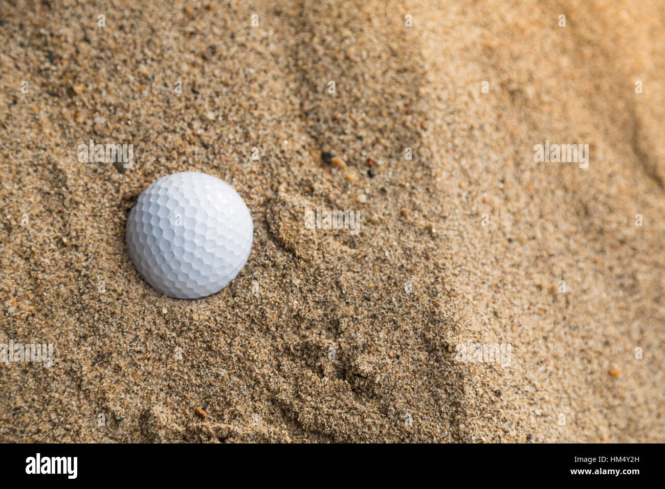Golf ball in sand bunker Stock Photo - Alamy