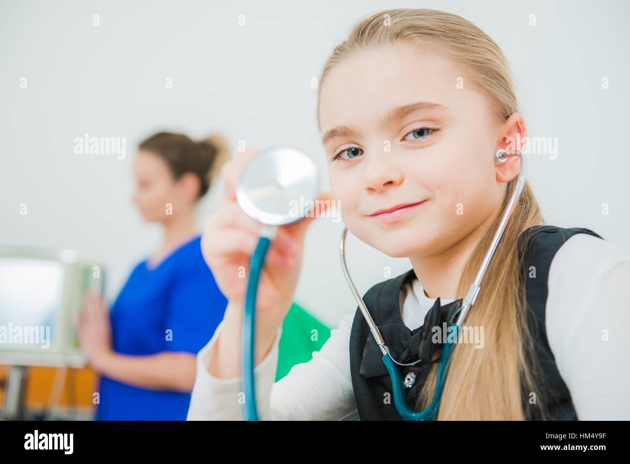 Caucasian Girl Playing Doctor Using Stethoscope in the Doctor Office ...