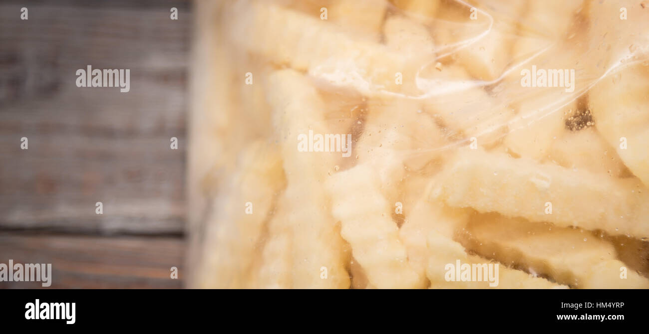 French fries package on wood background Stock Photo - Alamy