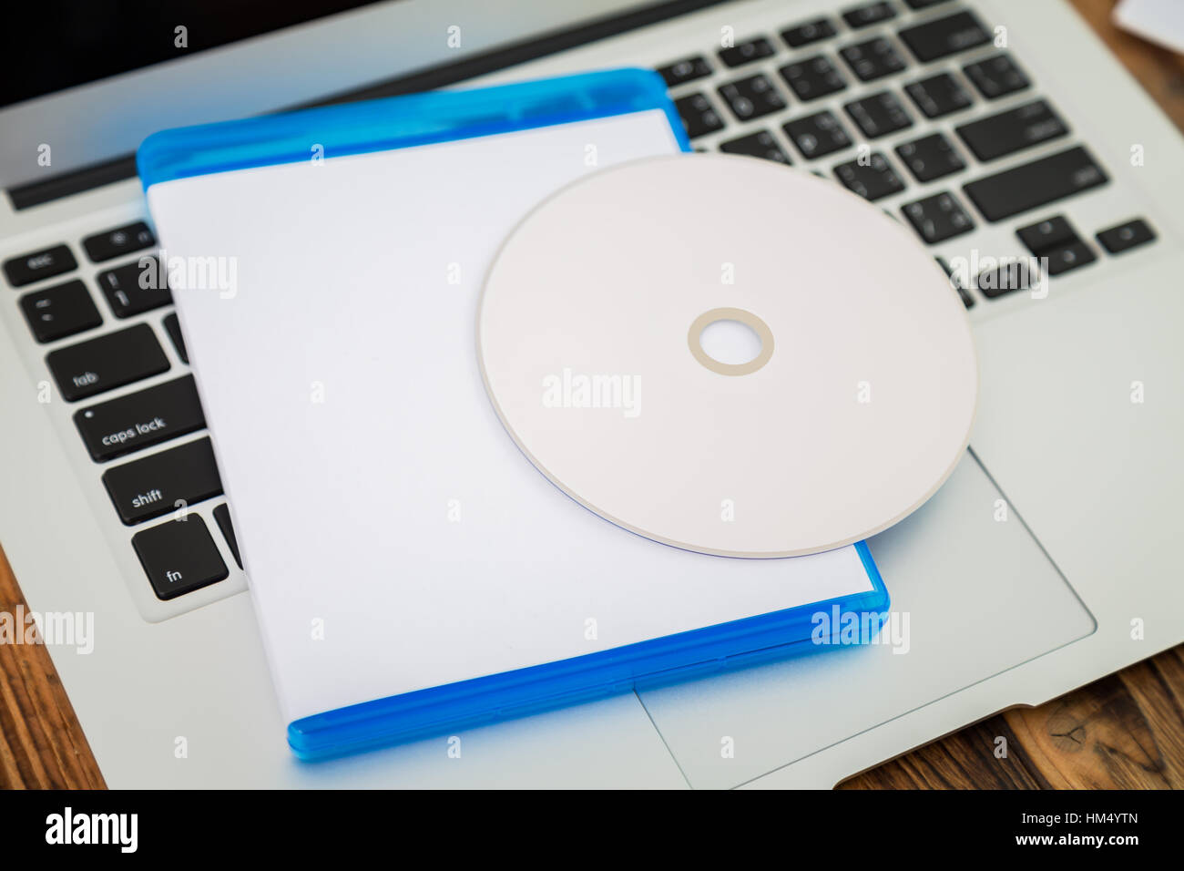Blank compact disc with cover on laptop keyboard Stock Photo - Alamy