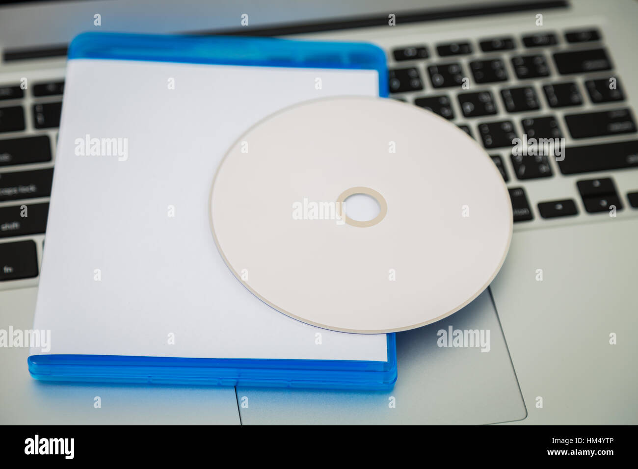 Blank compact disc with cover on laptop keyboard Stock Photo - Alamy