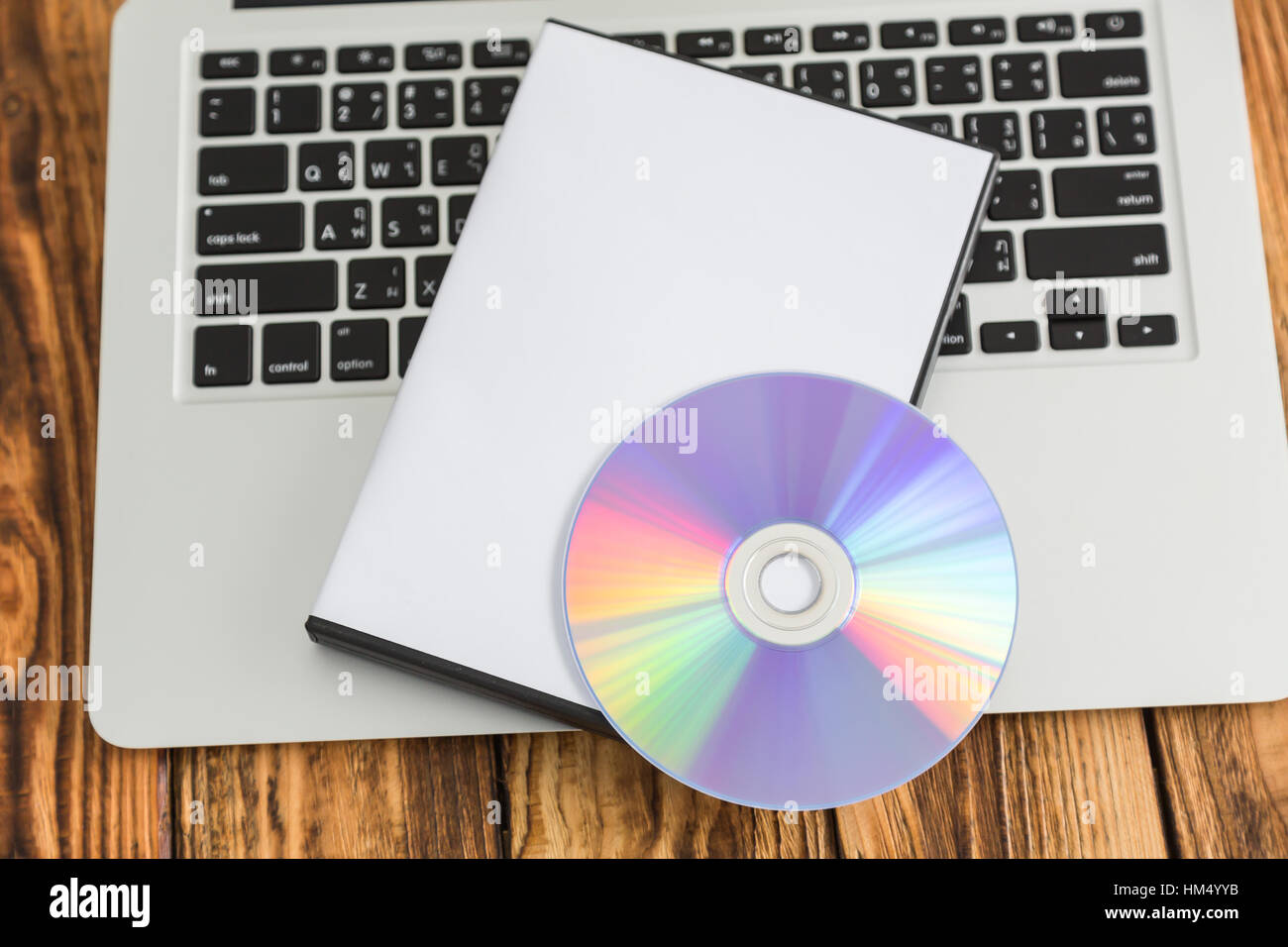 Blank compact disc with cover on laptop keyboard Stock Photo - Alamy