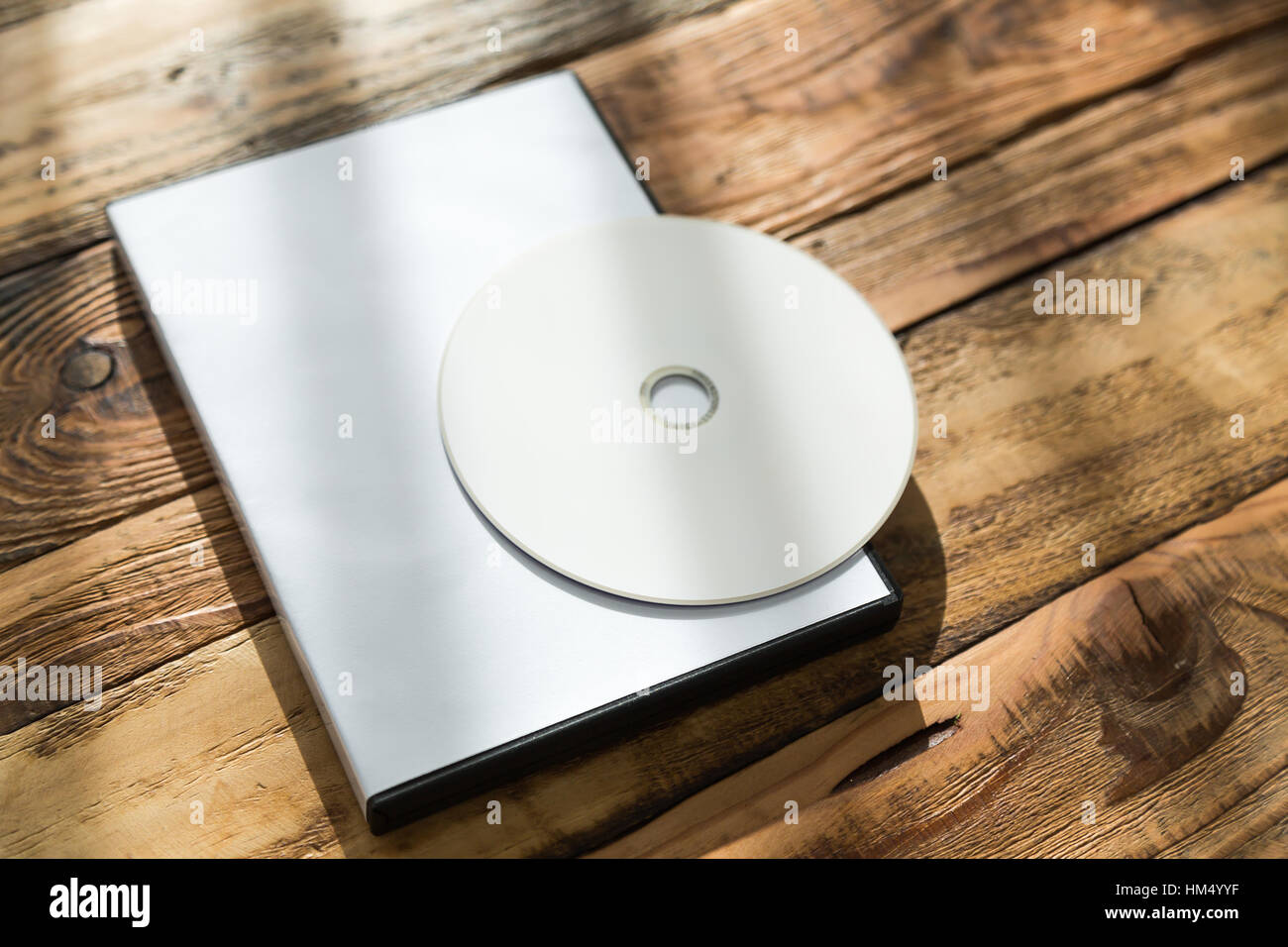Blank compact disc with cover on wood background ground Stock Photo - Alamy
