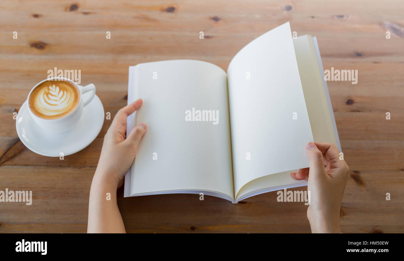 Hands open Blank catalog, magazines,book mock up on wood table with ...