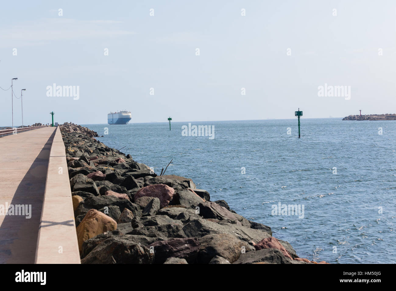 Ship ocean port entry through harbor piers and beacons Stock Photo - Alamy