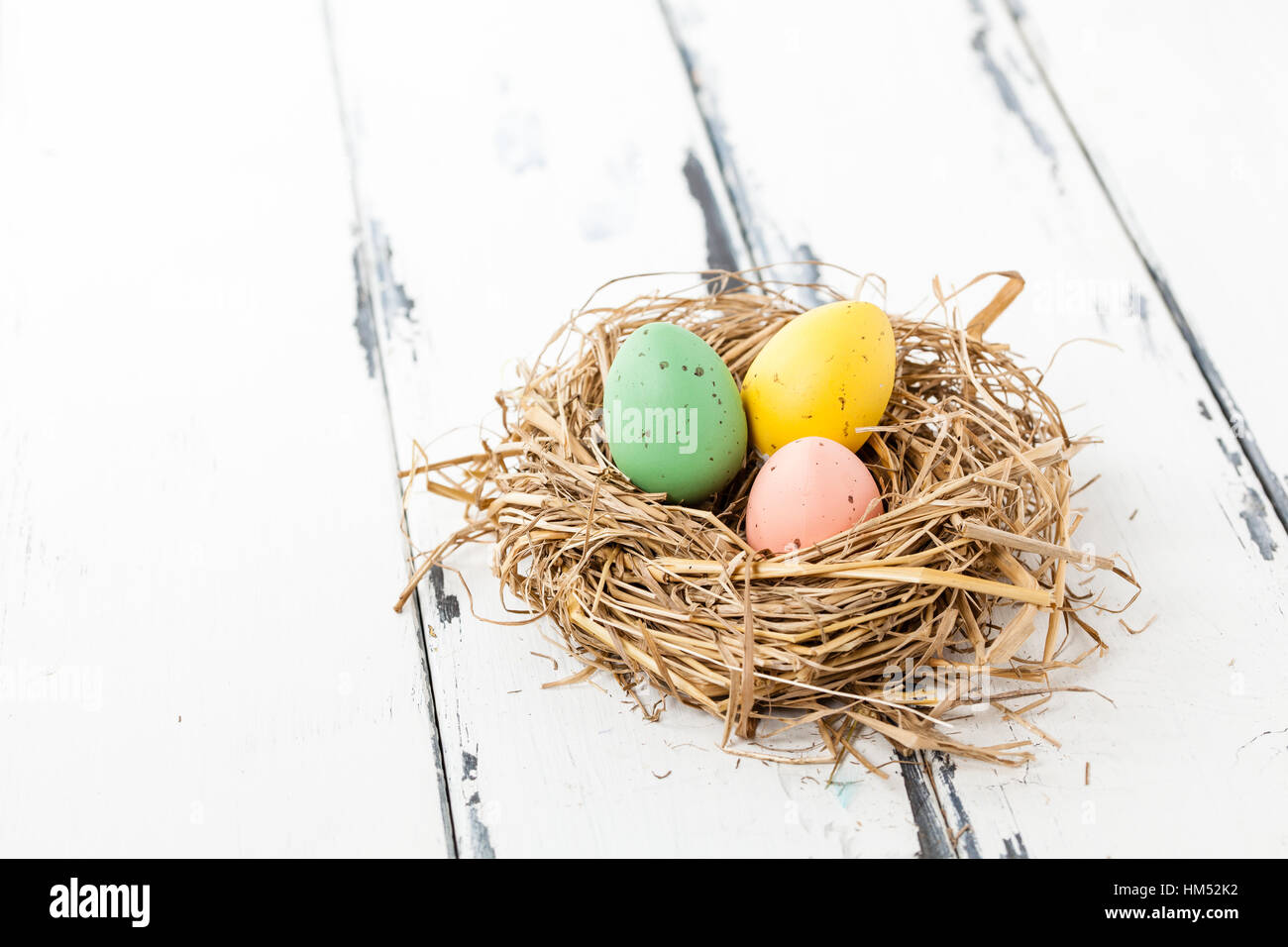 three ester eggs in a bird nest Stock Photo - Alamy