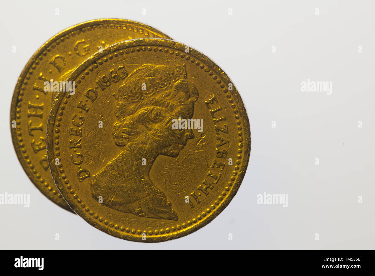 Two one pound coins on the white background Stock Photo - Alamy