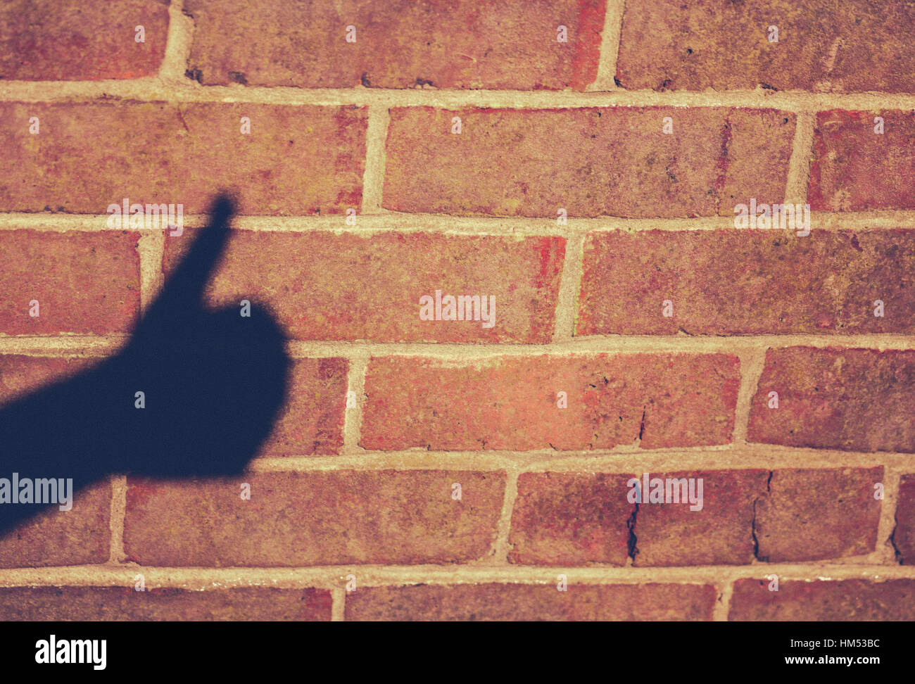 Shadow of a man's hand showing Thumbs Up sign Stock Photo - Alamy