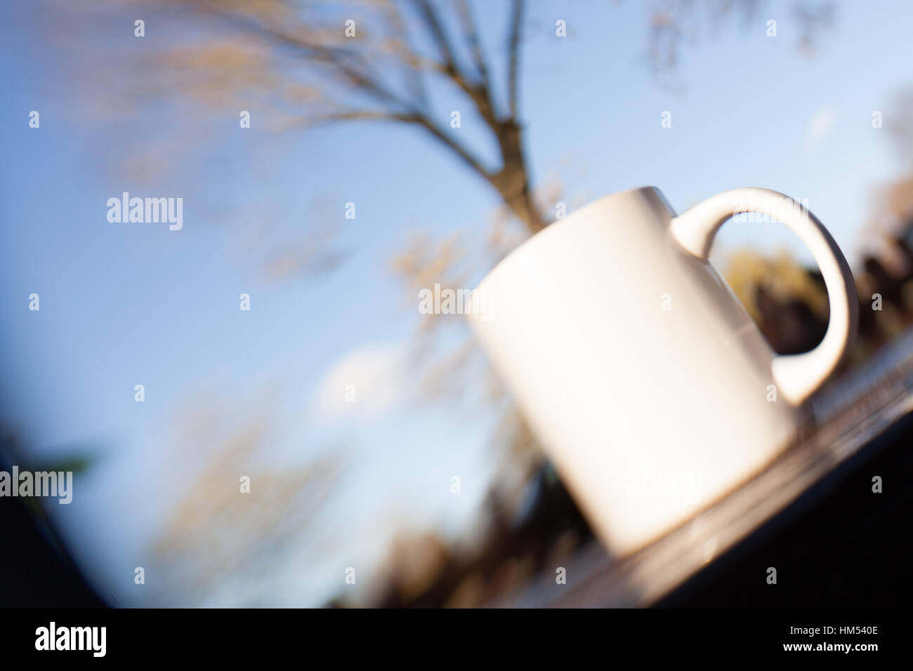 Coffee mug on an outside table in a cafe Stock Photo - Alamy