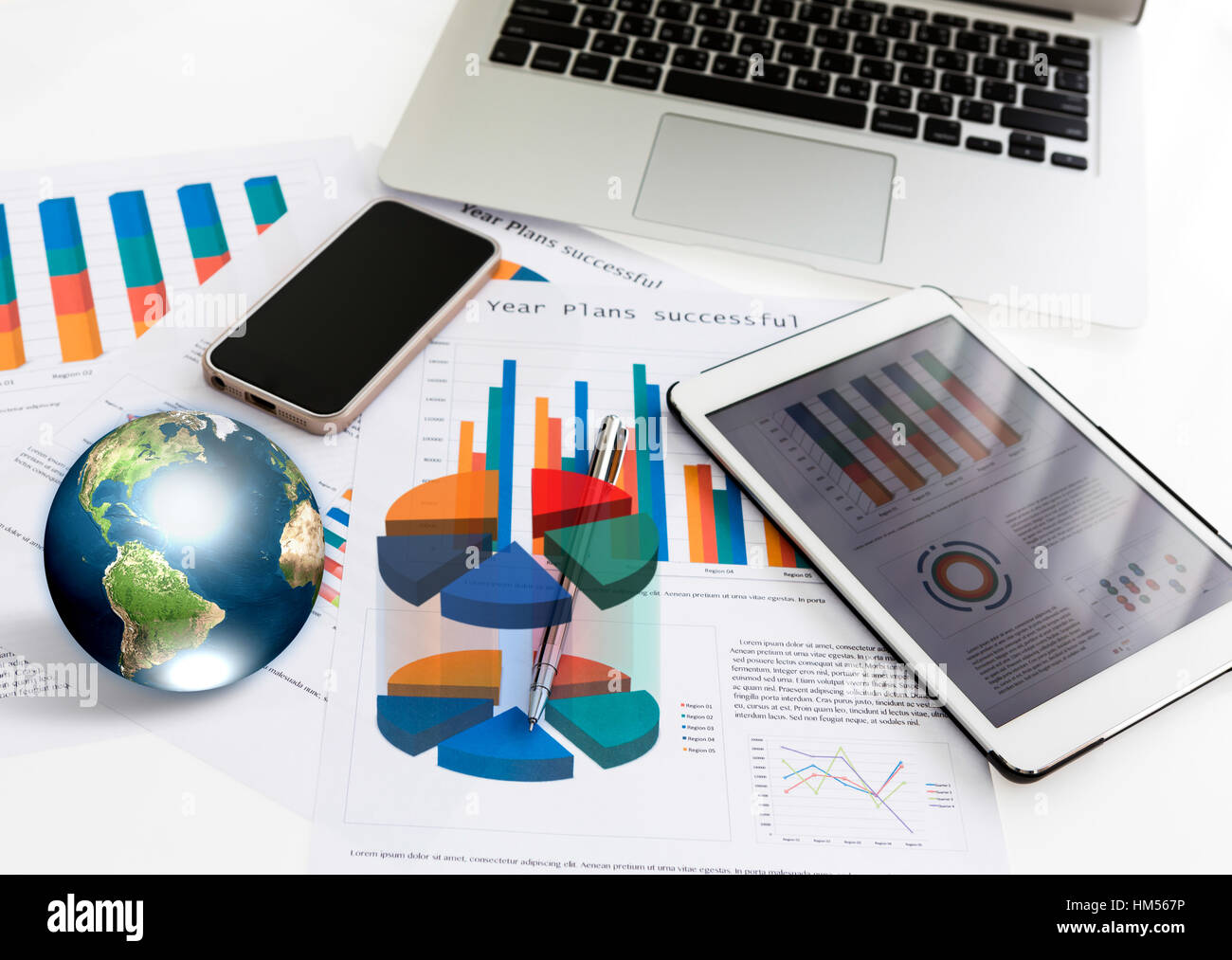 Financial charts on the table with tablet phone and pen (Elements of ...