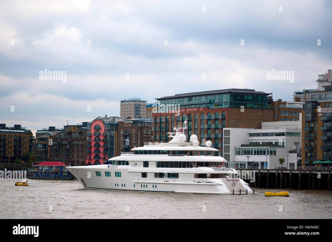 Luxury yacht on River Thames against Butlers Wharf skyline, London ...