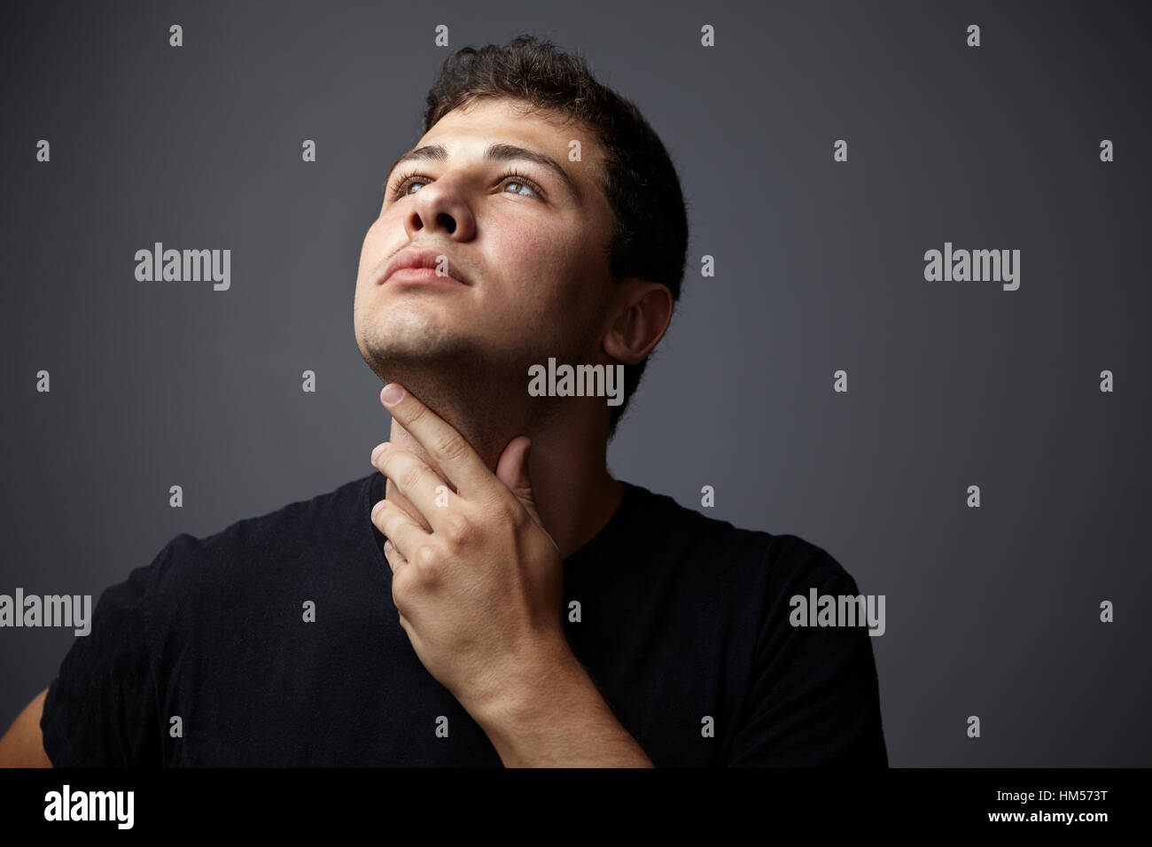 Young man wondering Stock Photo - Alamy