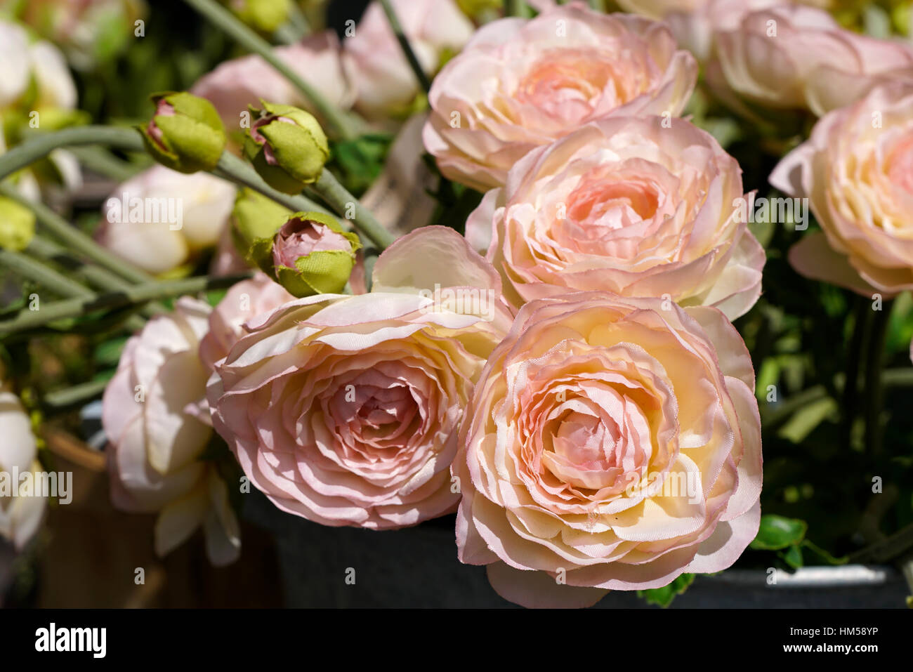 Silk pink flowers on display Stock Photo - Alamy