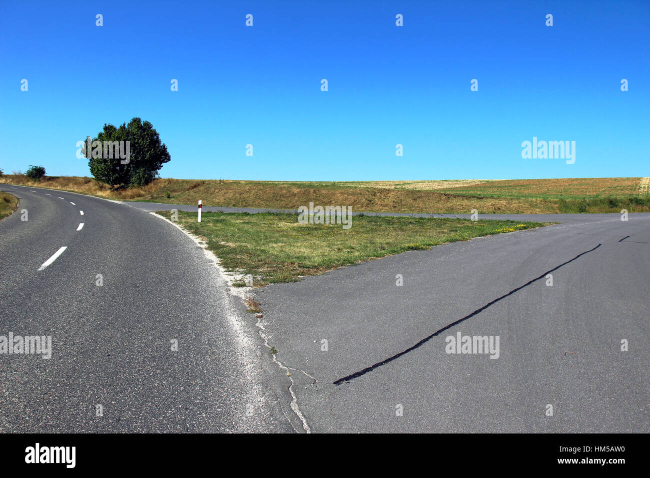 asphalt road triangle crossroad in nature Stock Photo - Alamy
