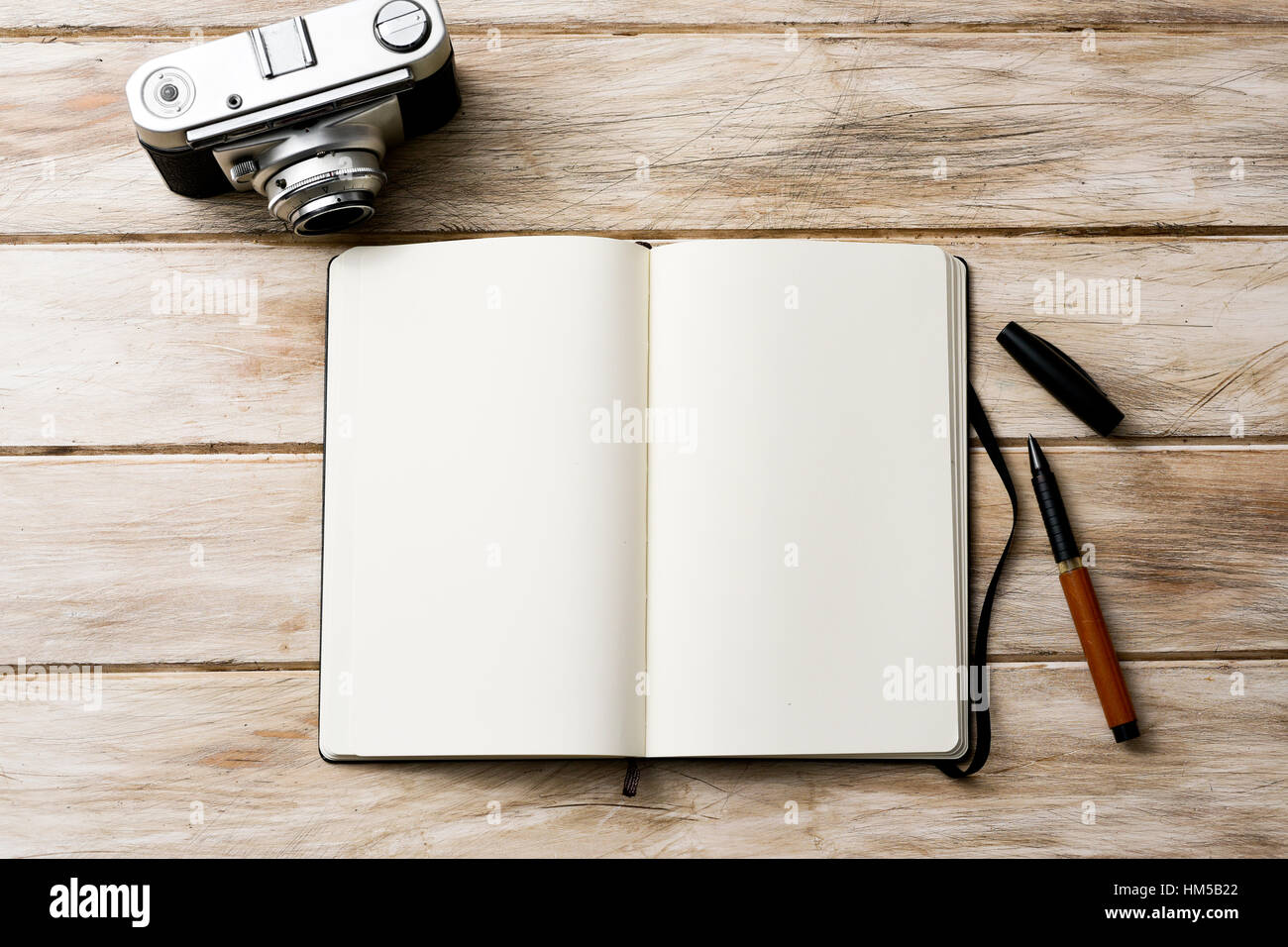 high-angle shot of an open notebook with a blank space, a pen and an ...