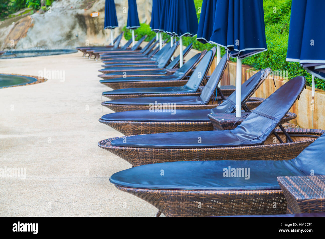 Swimming pool with relaxing seats Stock Photo - Alamy