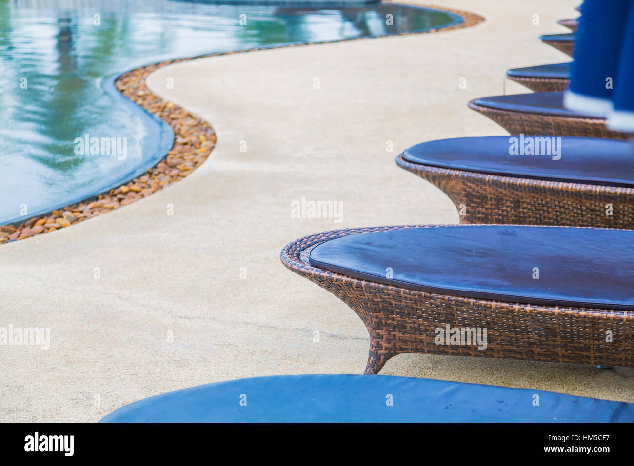 Swimming pool with relaxing seats Stock Photo - Alamy
