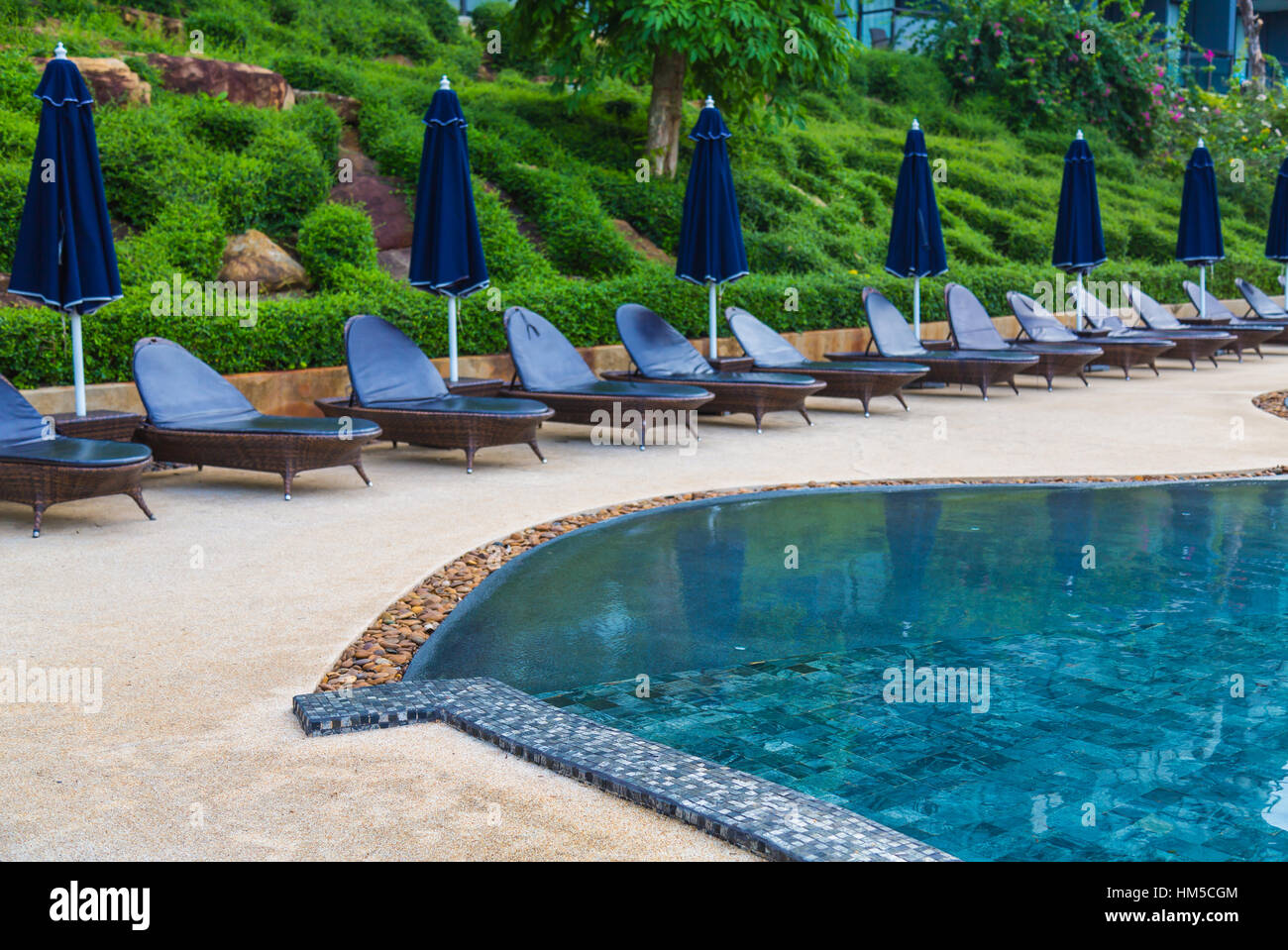 Swimming pool with relaxing seats Stock Photo - Alamy