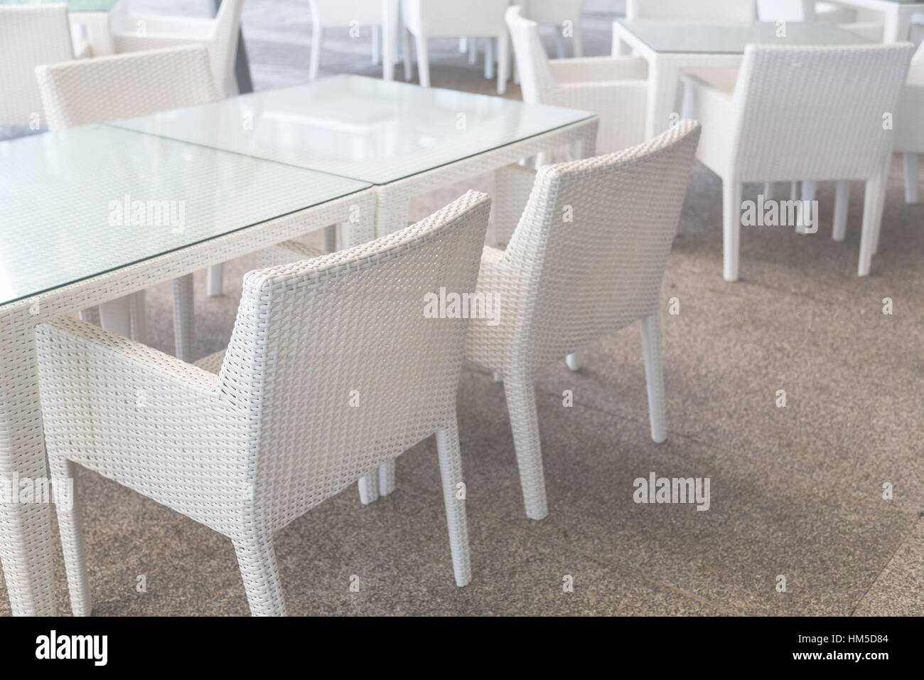 White tables and chairs in restaurant Stock Photo - Alamy