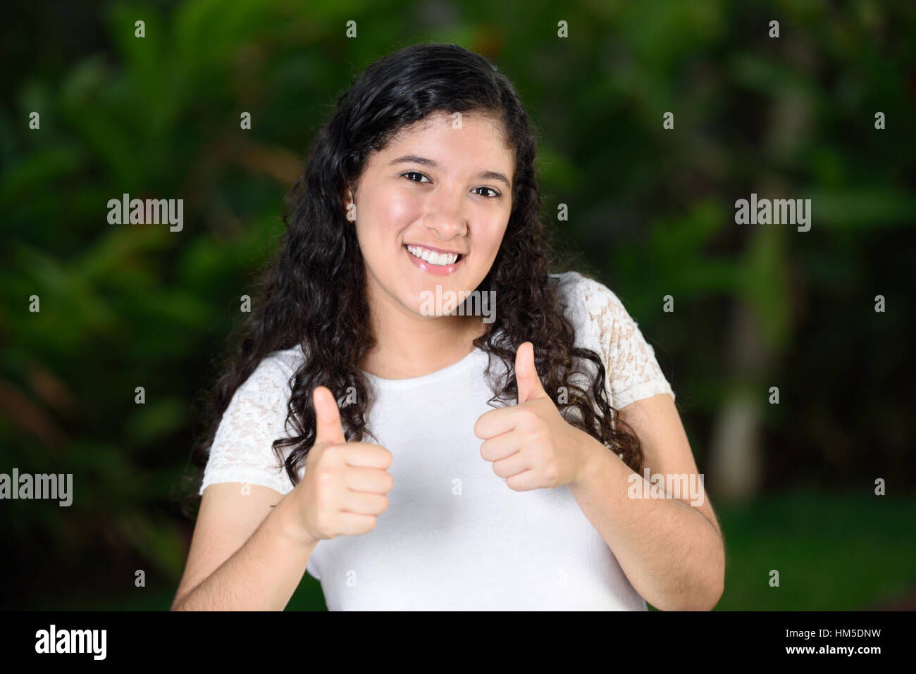 girl smiling with the thumbs up Stock Photo - Alamy