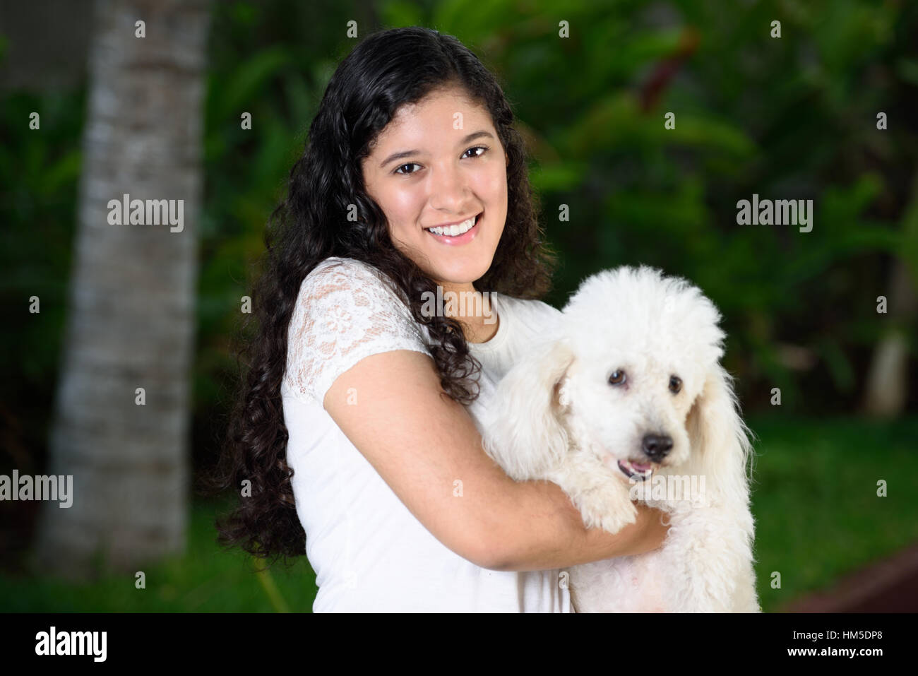 teen girl embracing a white poodle dog Stock Photo - Alamy