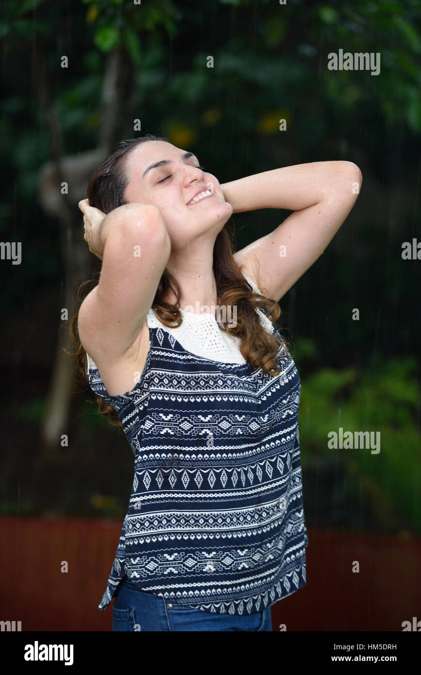 young wet woman enjoy heavy tropical rain Stock Photo - Alamy