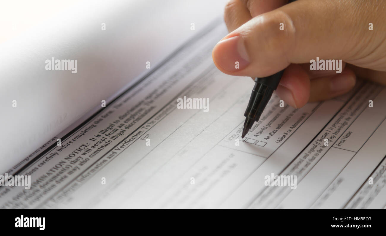 Hand with pen over application form Stock Photo - Alamy