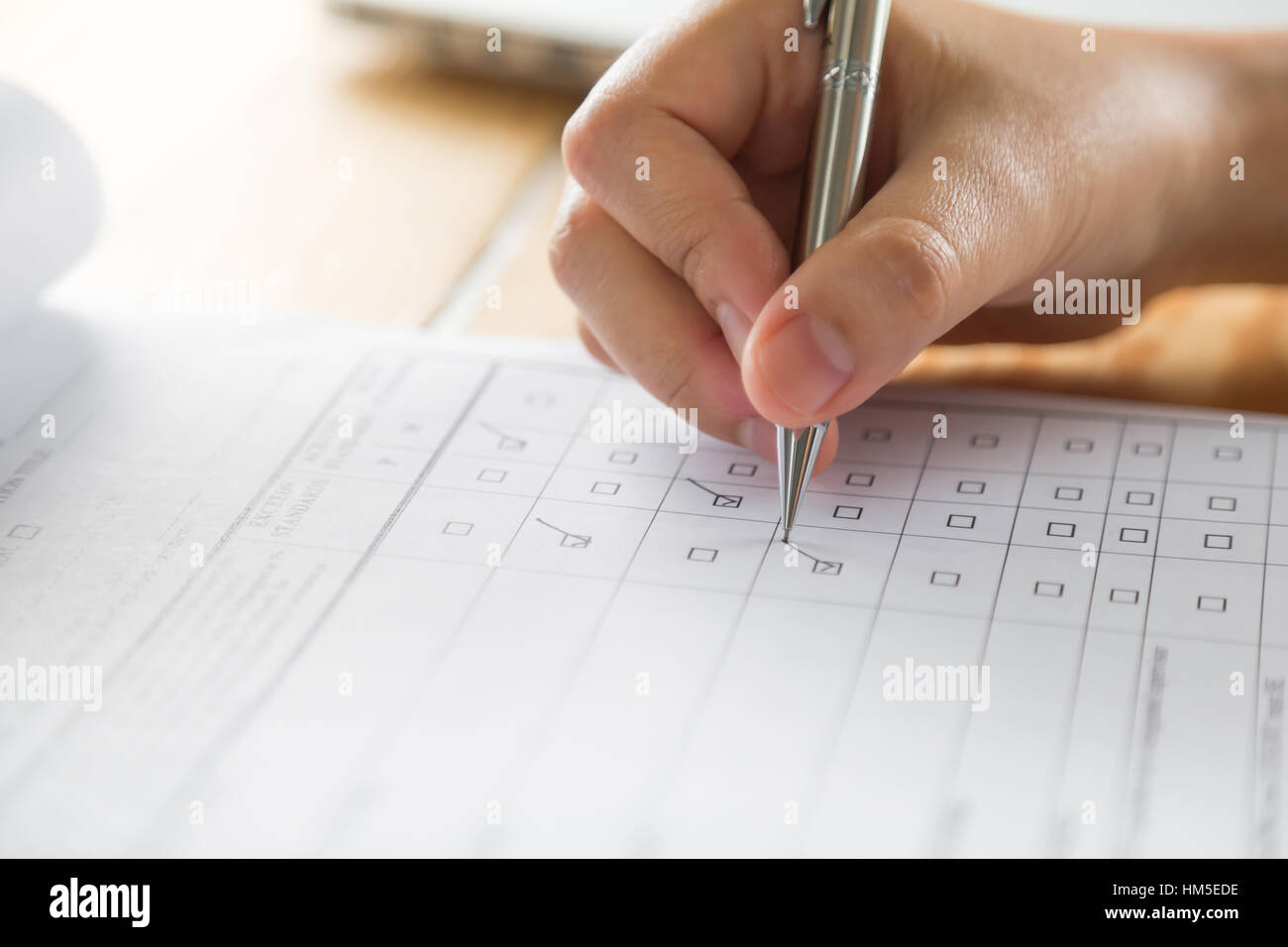 Hand with pen over application form Stock Photo - Alamy