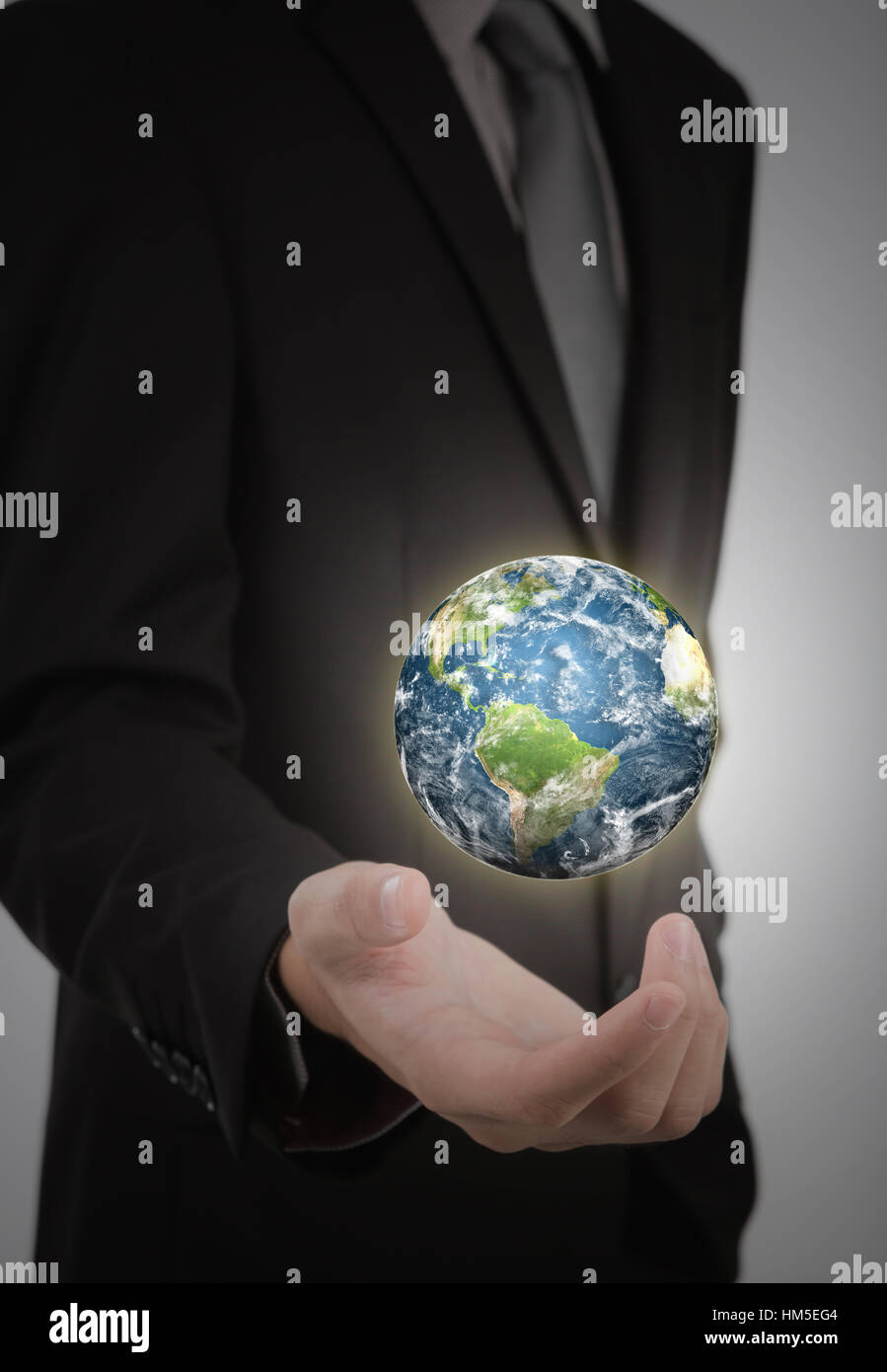 Business man holding earth in his hand (Elements of this image ...