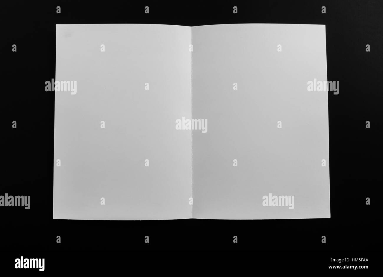 Bifold white template paper on black background Stock Photo - Alamy