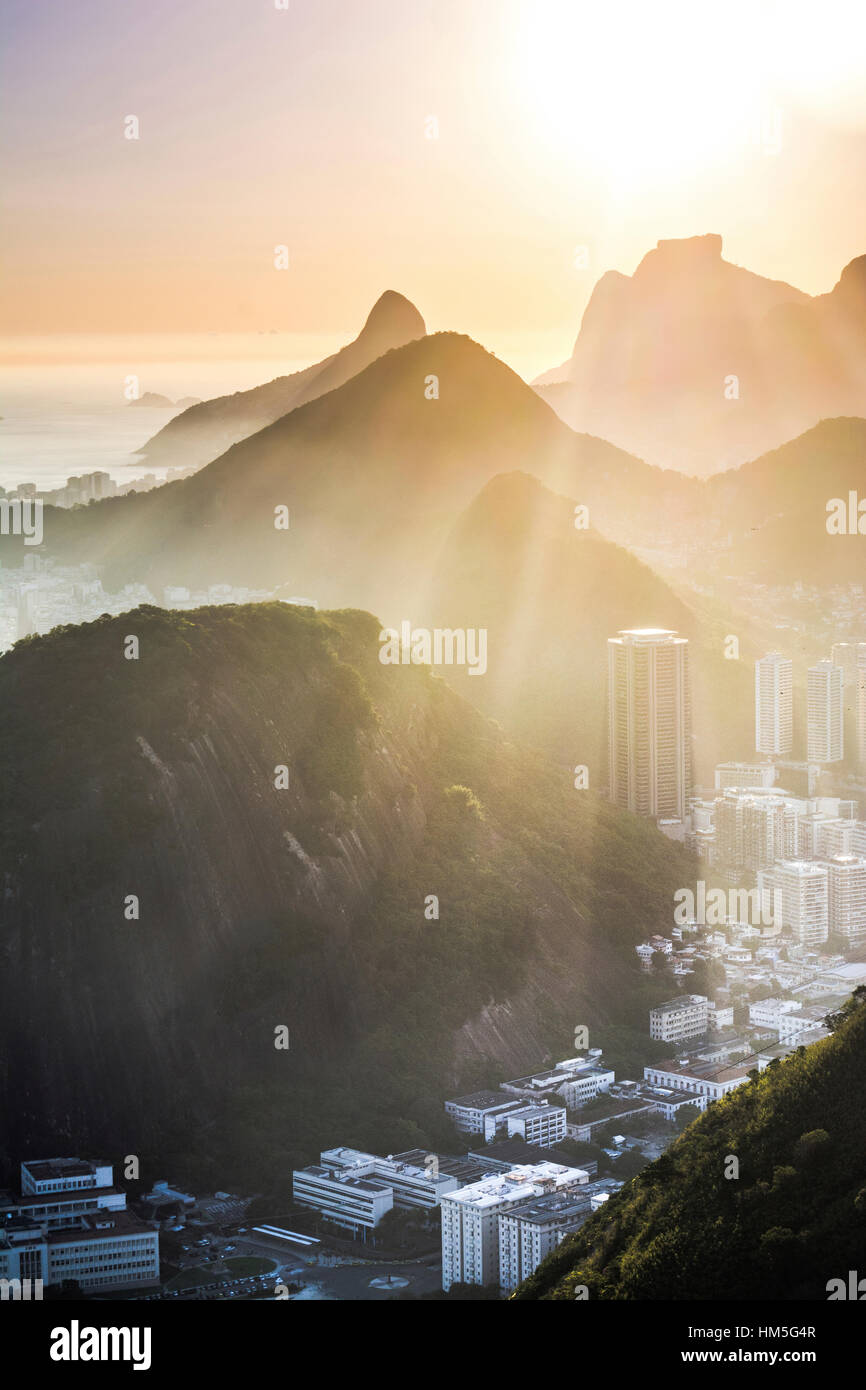 View of sunlight falling on mountains by residential buildings in ...