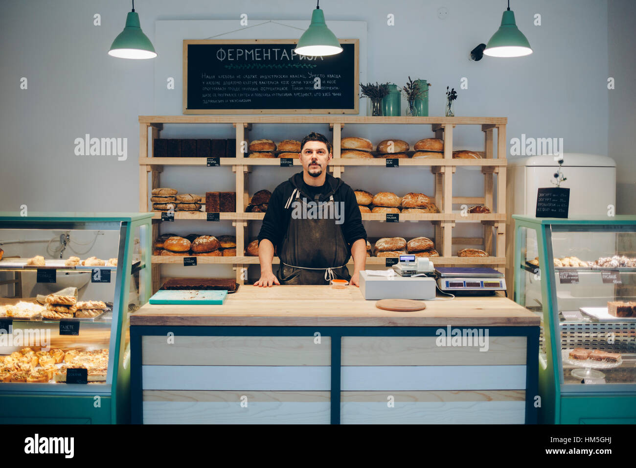 Portrait of confident baker standing at counter in bakery Stock Photo ...
