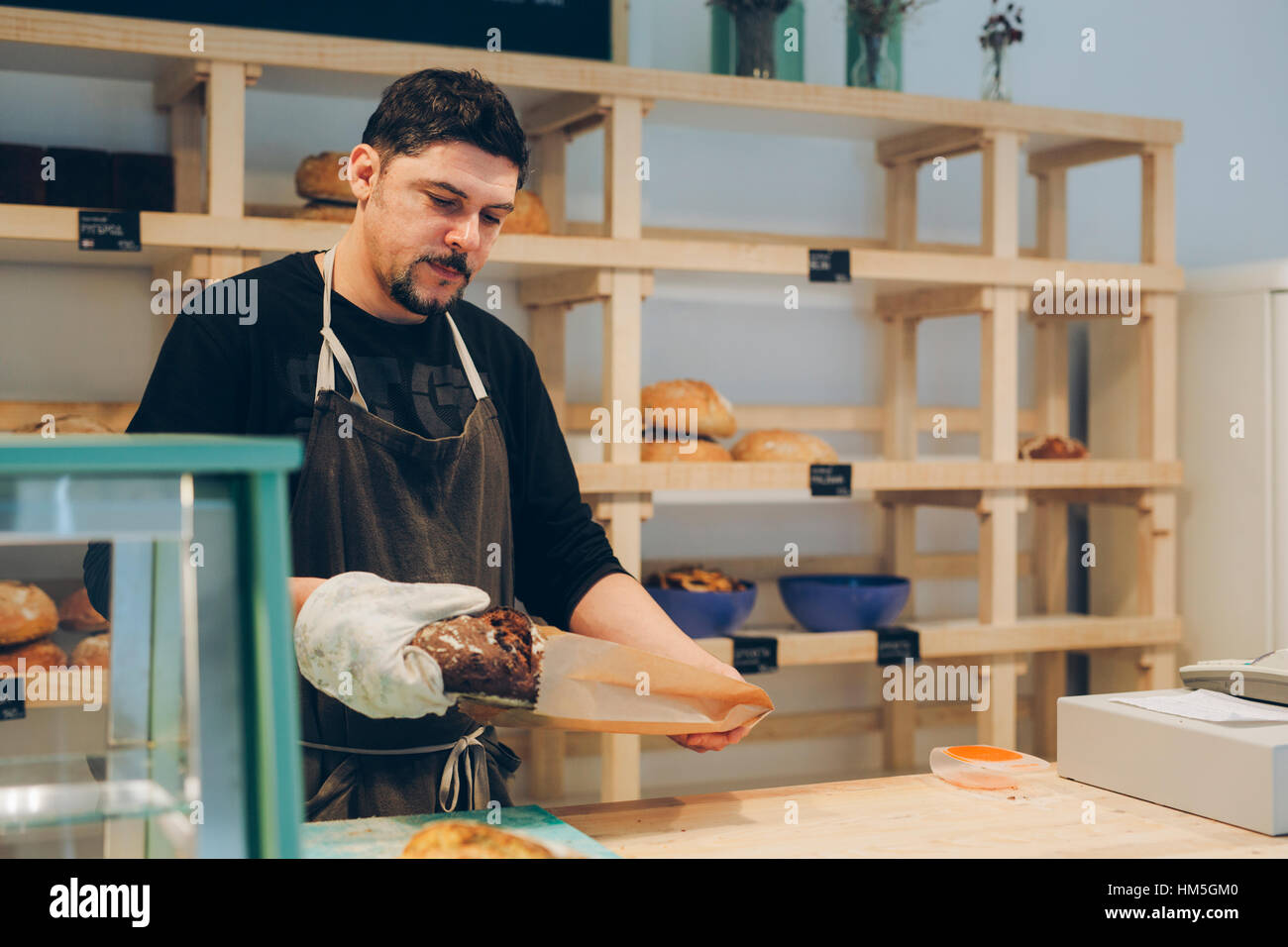 Male bakery owner packing hi-res stock photography and images - Alamy