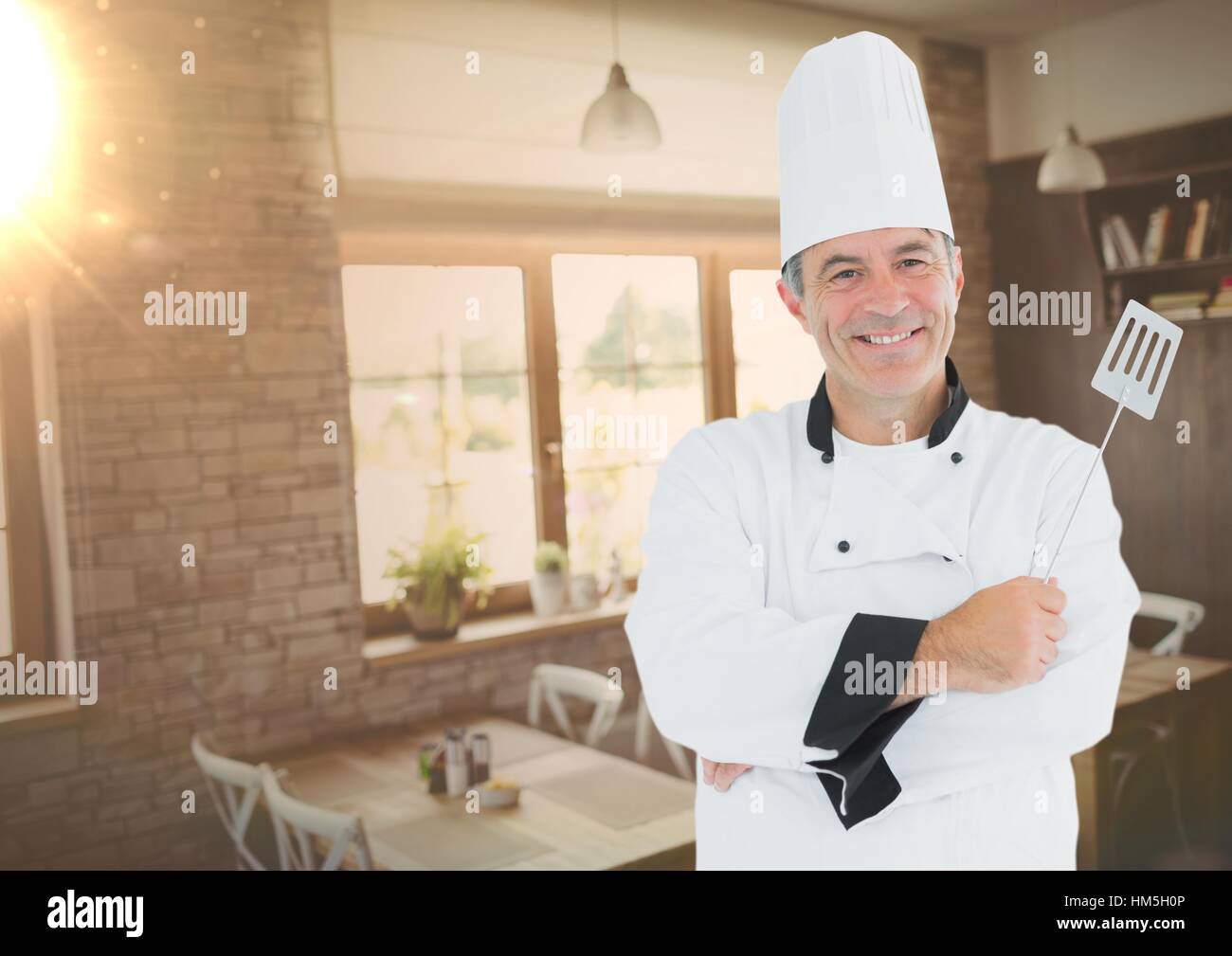 Male chef holding frying spoon in restaurant Stock Photo - Alamy