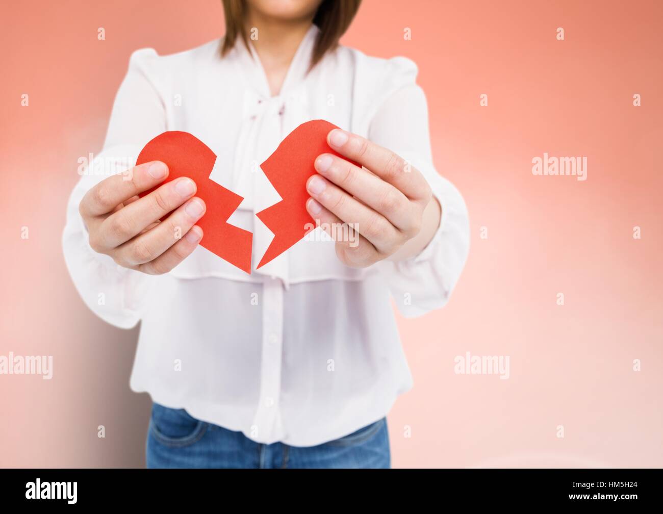 Mid-section of a woman holding a broken heart Stock Photo - Alamy