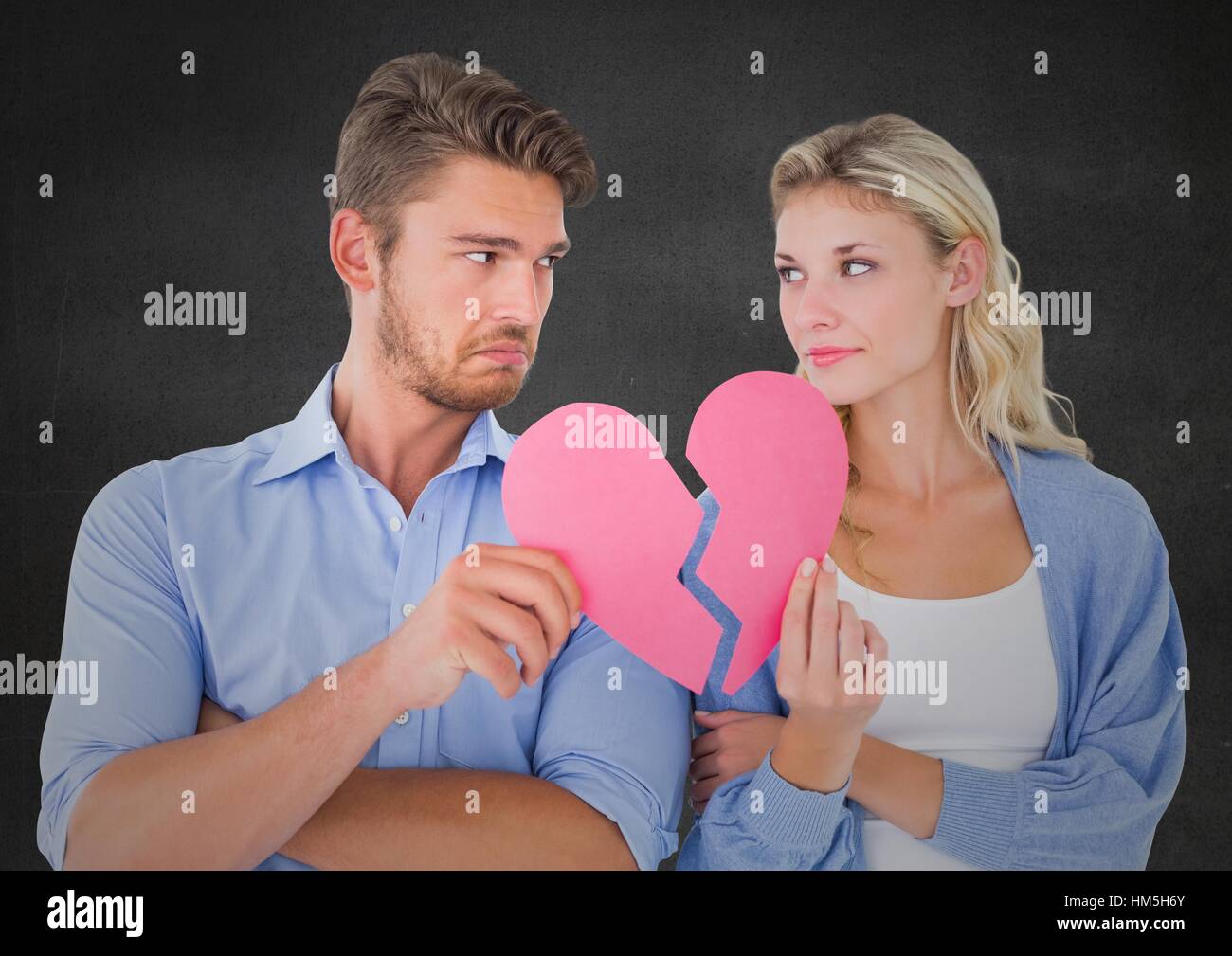 Depressed couple holding broken heart Stock Photo - Alamy