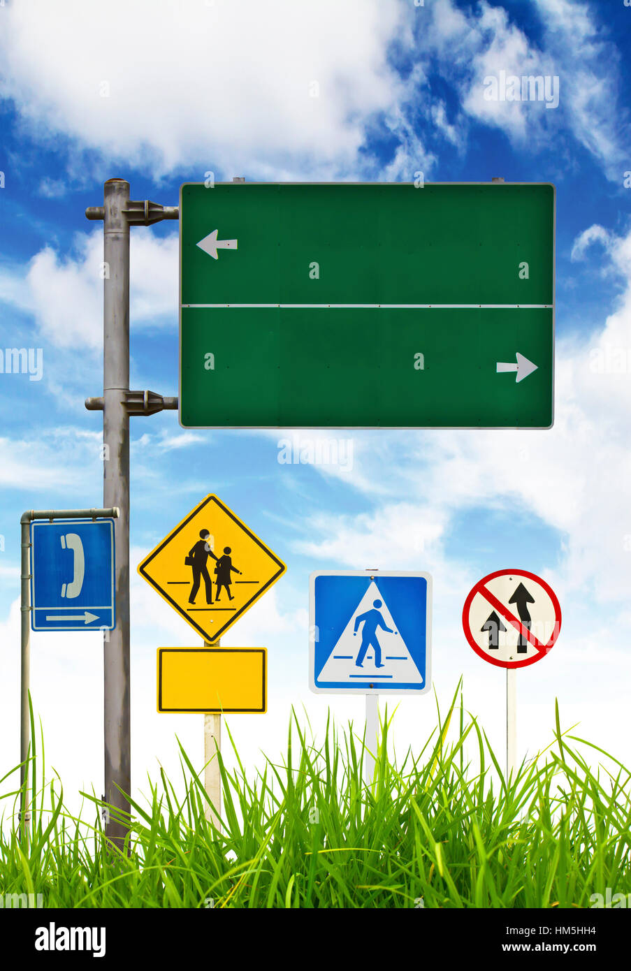 Traffic signs on green grass and blue sky Stock Photo - Alamy