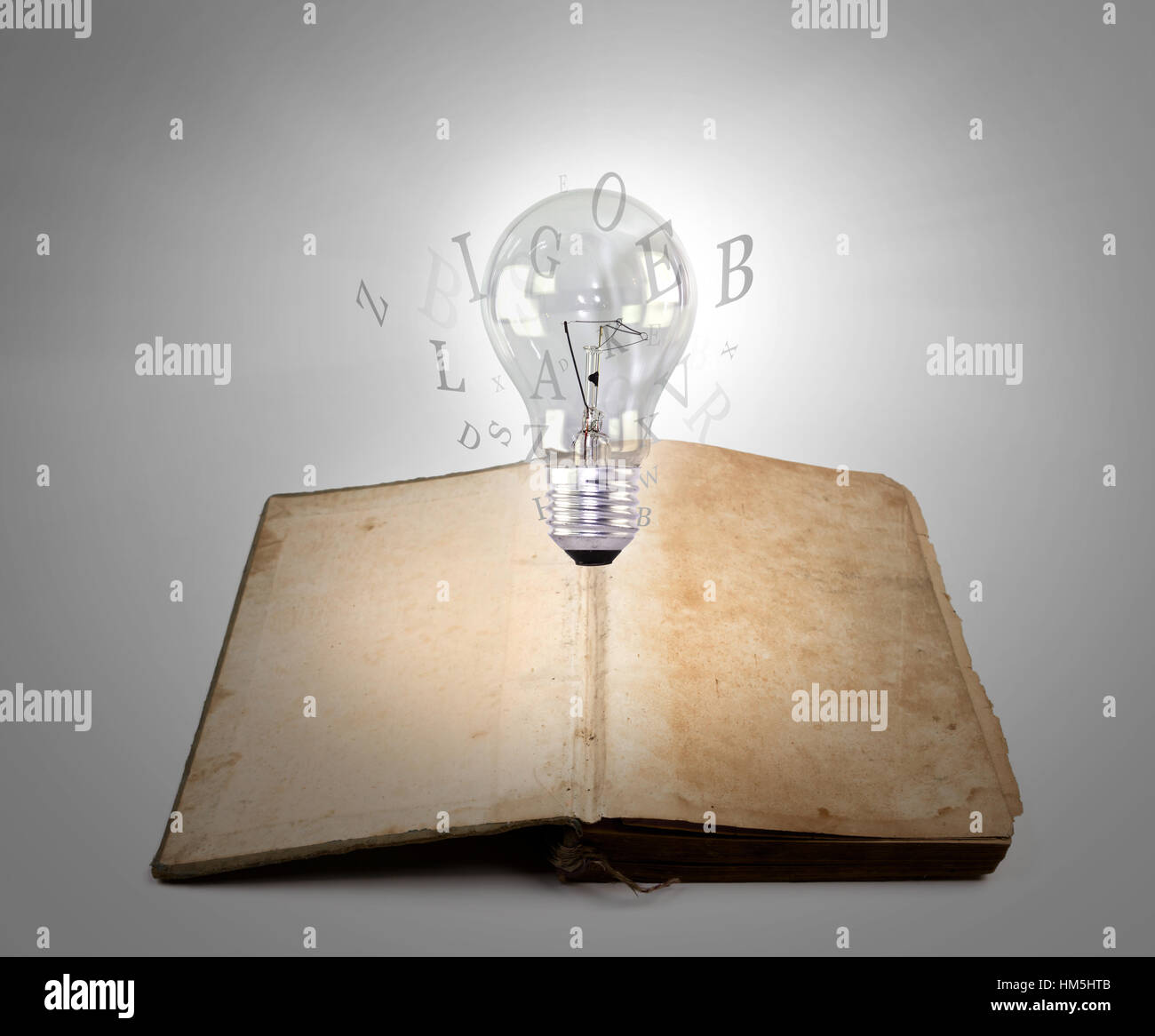 Book and light bulb Stock Photo - Alamy