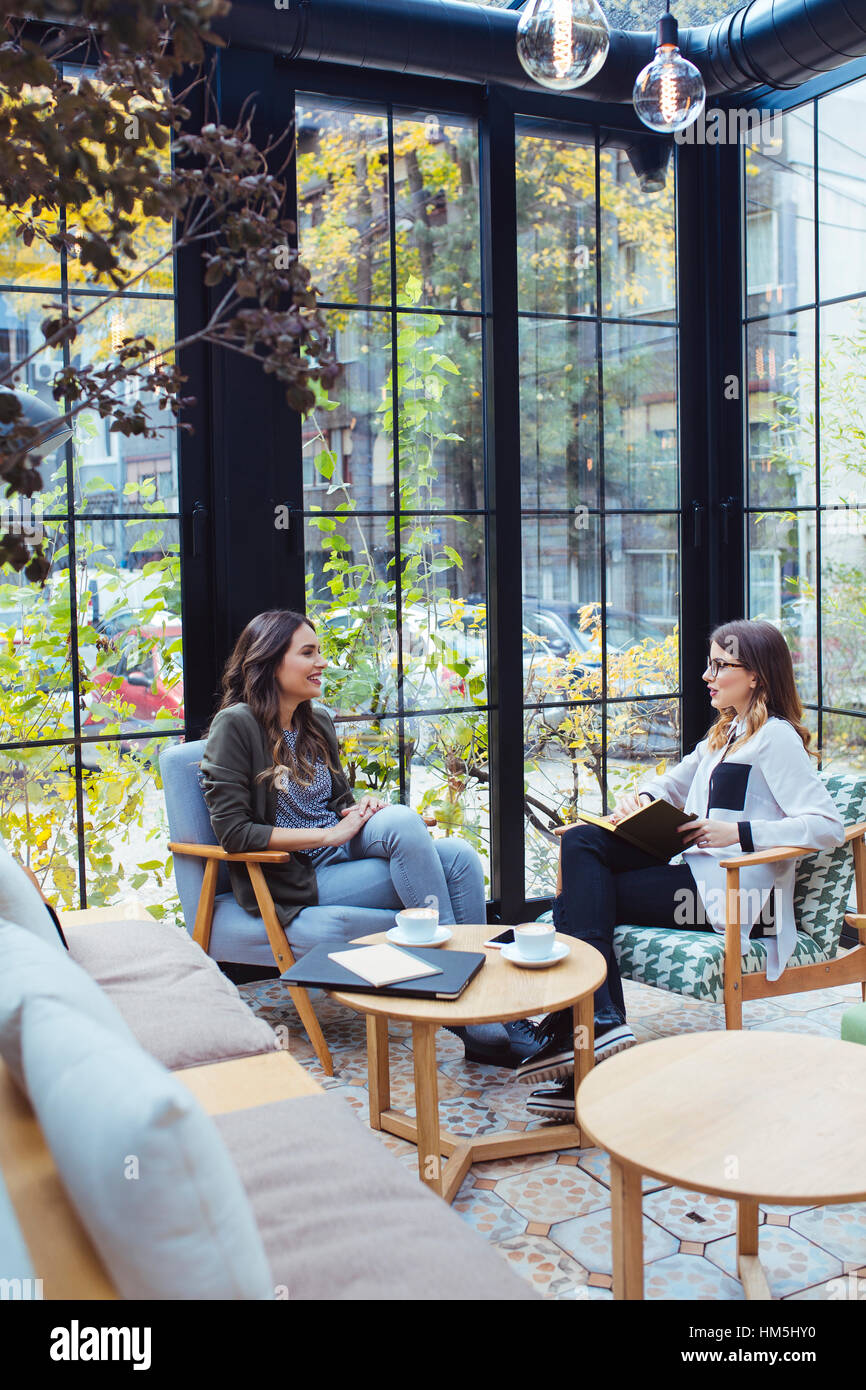 workers talking in cafe Stock Photo - Alamy