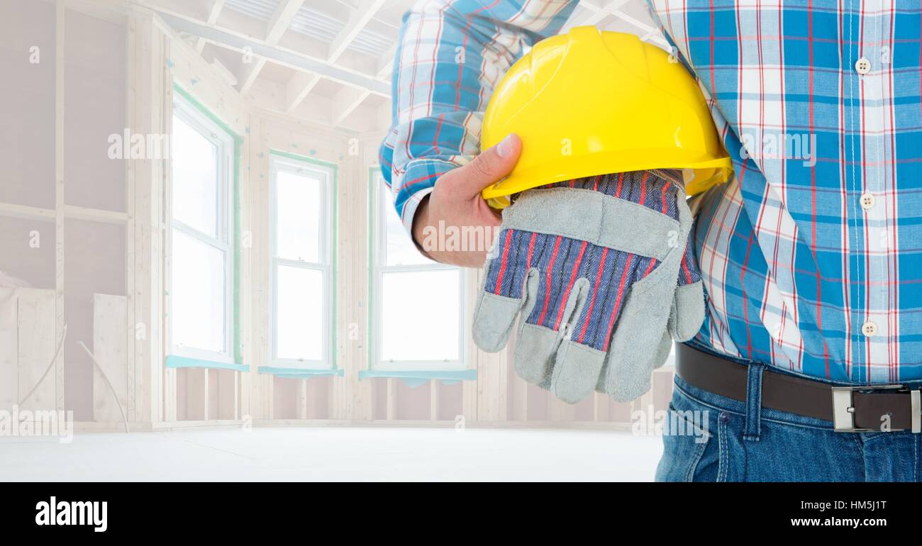 Construction worker holding hard hat hi-res stock photography and ...