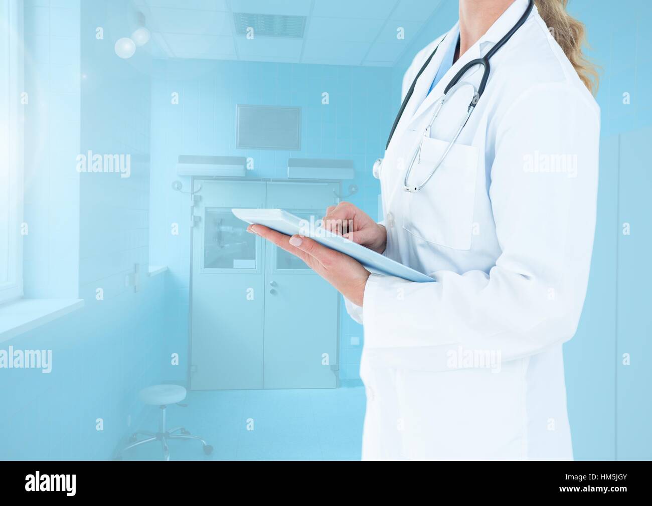 Mid section of female doctor using digital tablet Stock Photo - Alamy