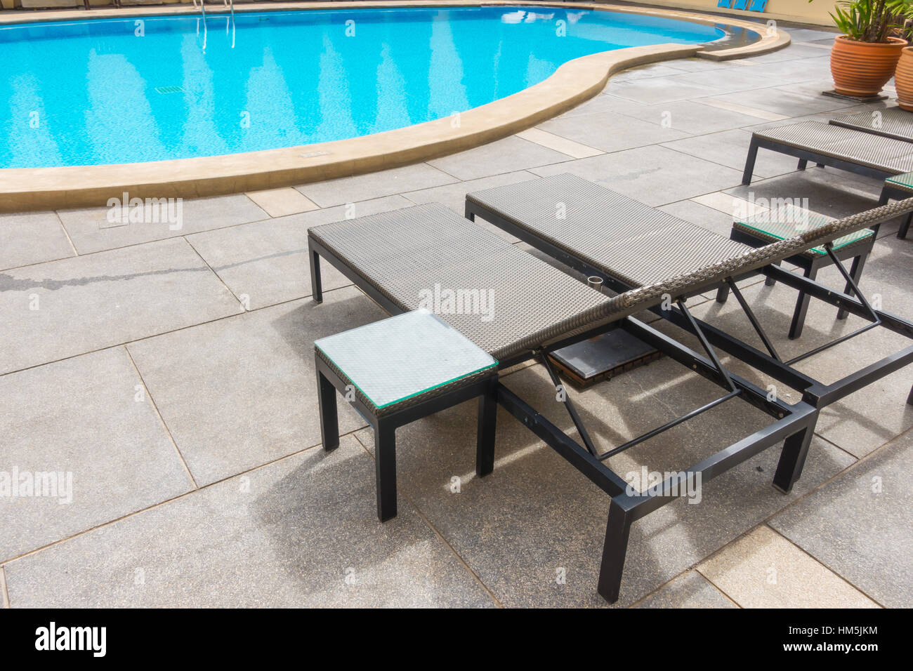 Swimming pool with relaxing seats Stock Photo - Alamy
