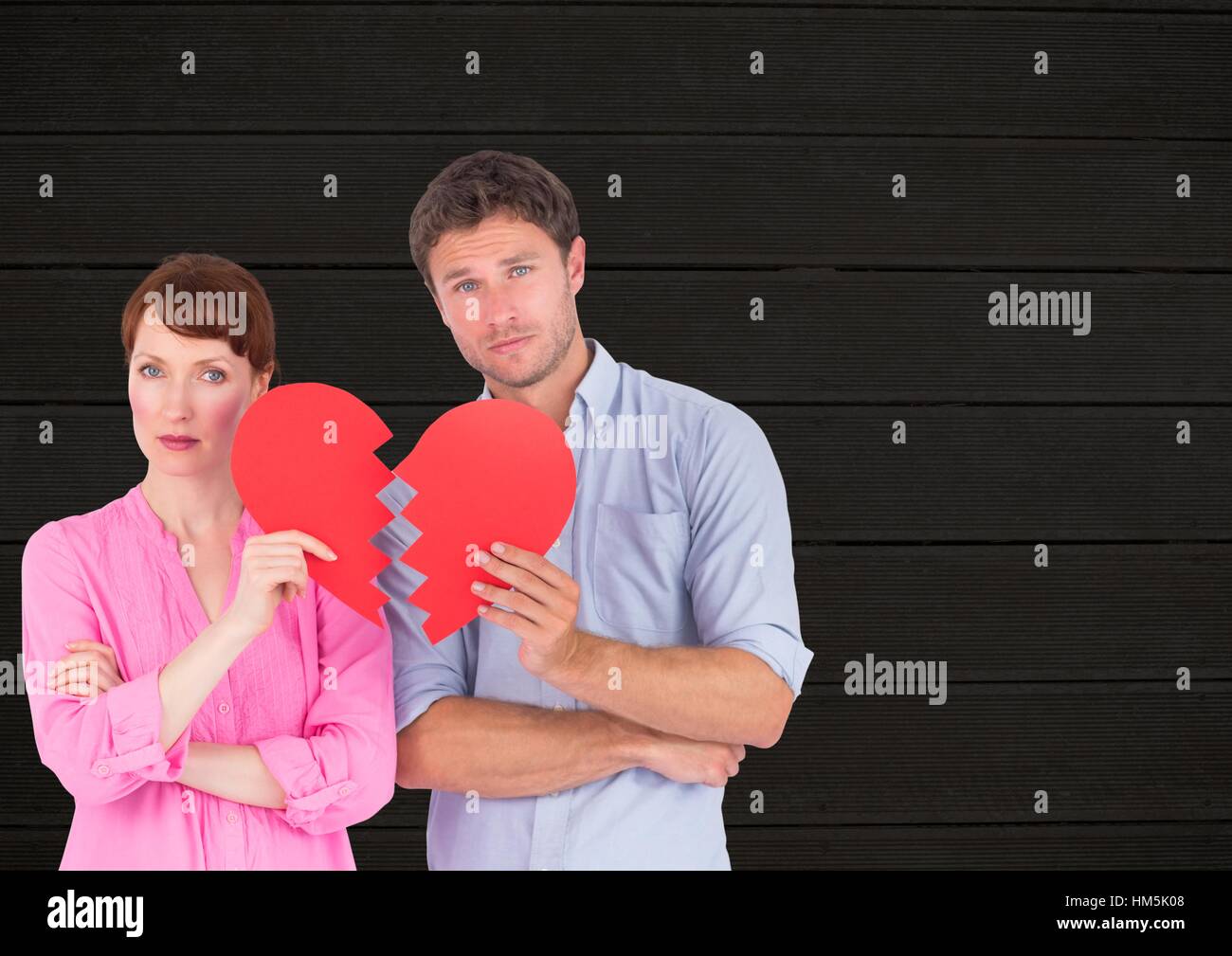 Sad couple holding broken heart Stock Photo - Alamy