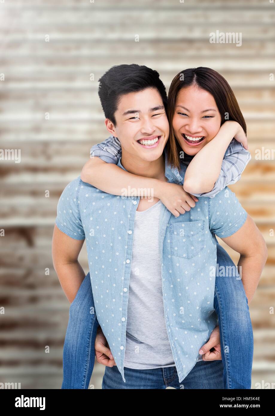 Happy man giving piggy back to woman Stock Photo - Alamy