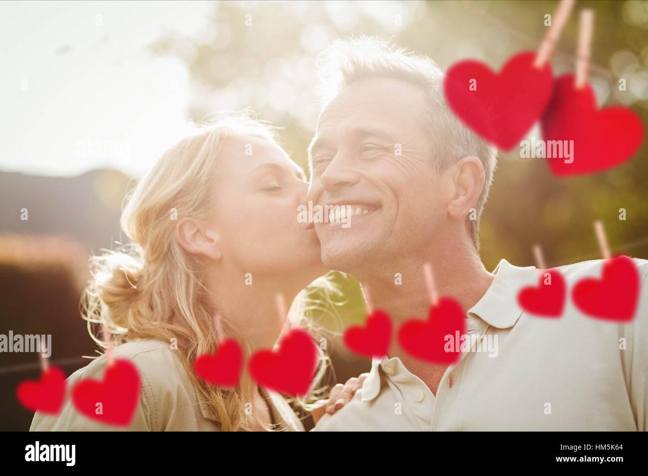 Affectionate woman kissing man Stock Photo - Alamy