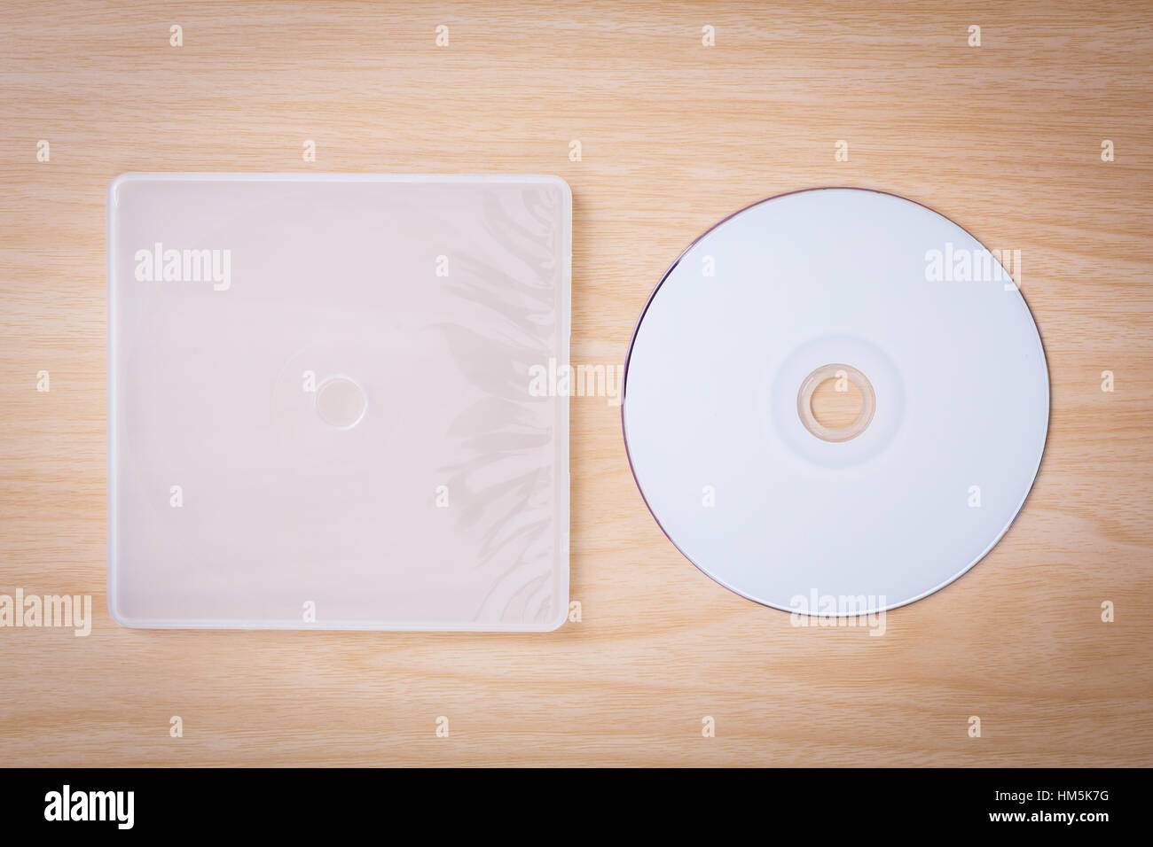 Blank compact disc with cover on wood background ground Stock Photo - Alamy